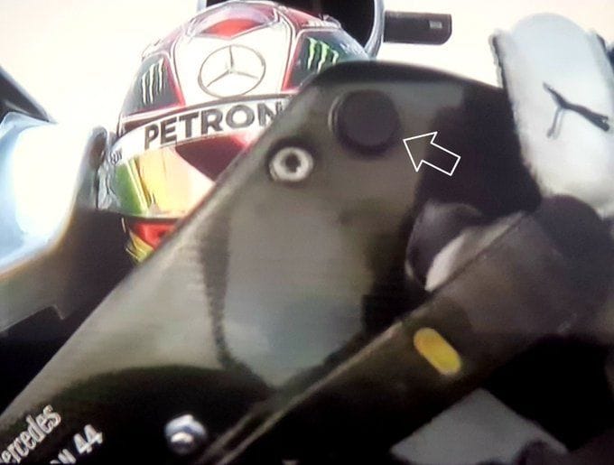 Why does Lewis Hamilton hold the steering wheel from the upper side?